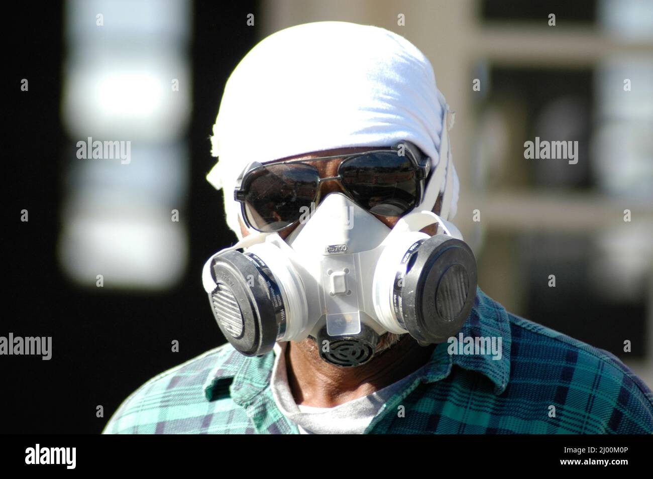 Man wearing saftey mask and breather working on rebuilding commrcial ...