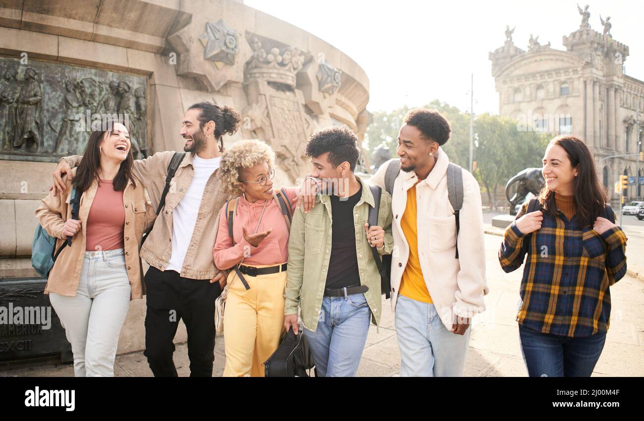 Group of young friends walking outdoors at the city. College students ... Group of young friends walking outdoors at the city. College students ...