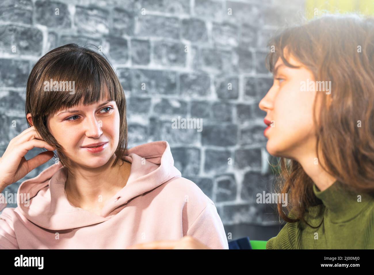 Two women friends gossiping hi-res stock photography and images - Alamy