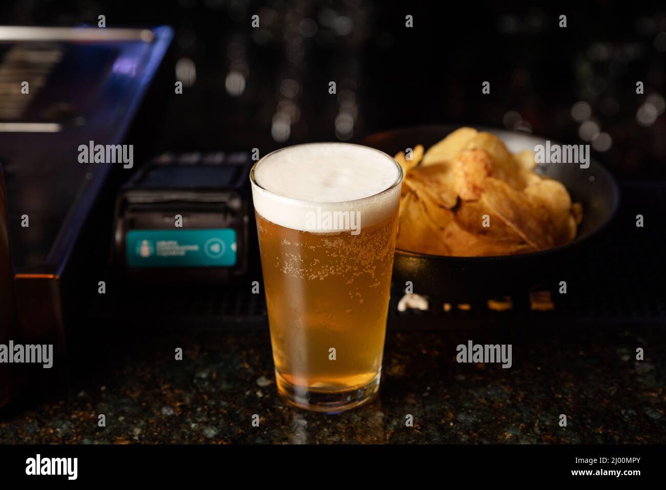 glass of beer on the bar counter Stock Photo - Alamy