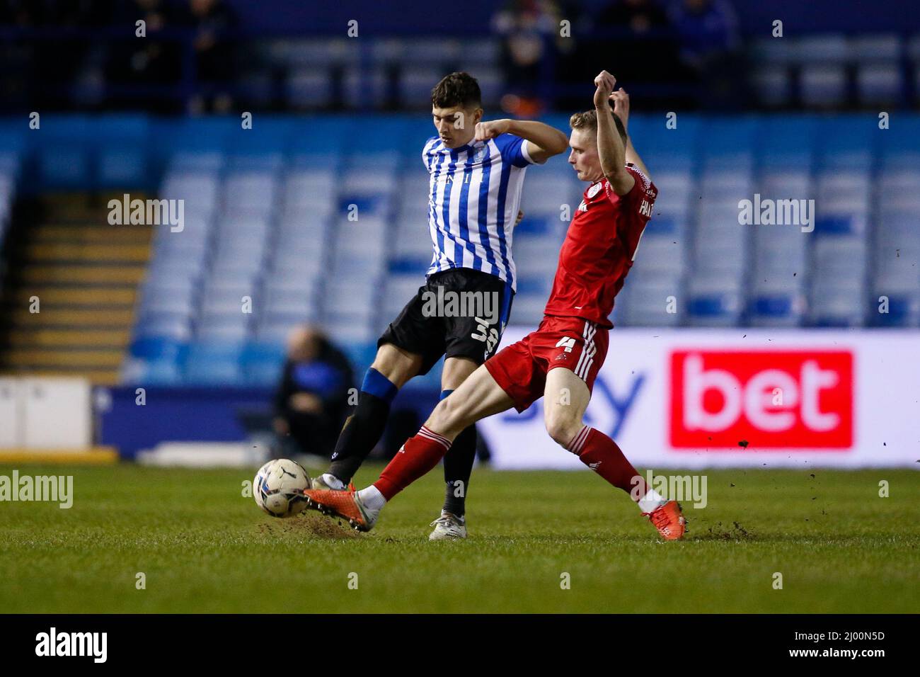Jordan Storey #38 of Sheffield Wednesday and Ethan Hamilton #4 of ...