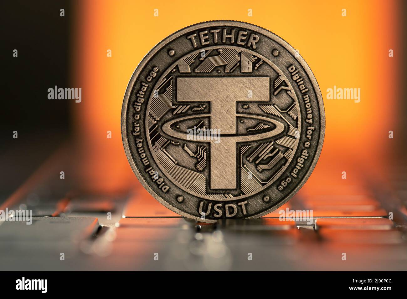Tether USDT Cryptocurrency physical coin placed on laptop keyboard and ...
