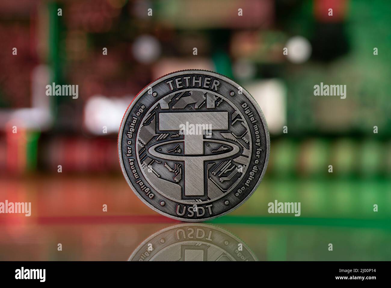 Tether USDT cryptocurrency physical coin placed on reflective surface ...