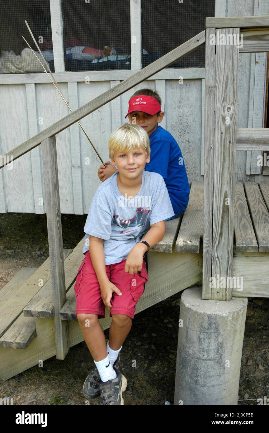 Two friends on steps at camp Stock Photo - Alamy
