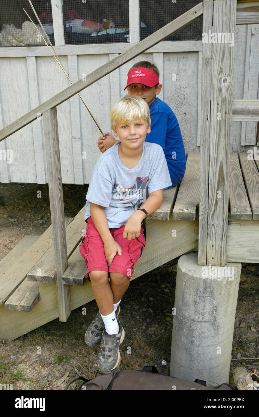 Two friends on steps at camp Stock Photo - Alamy