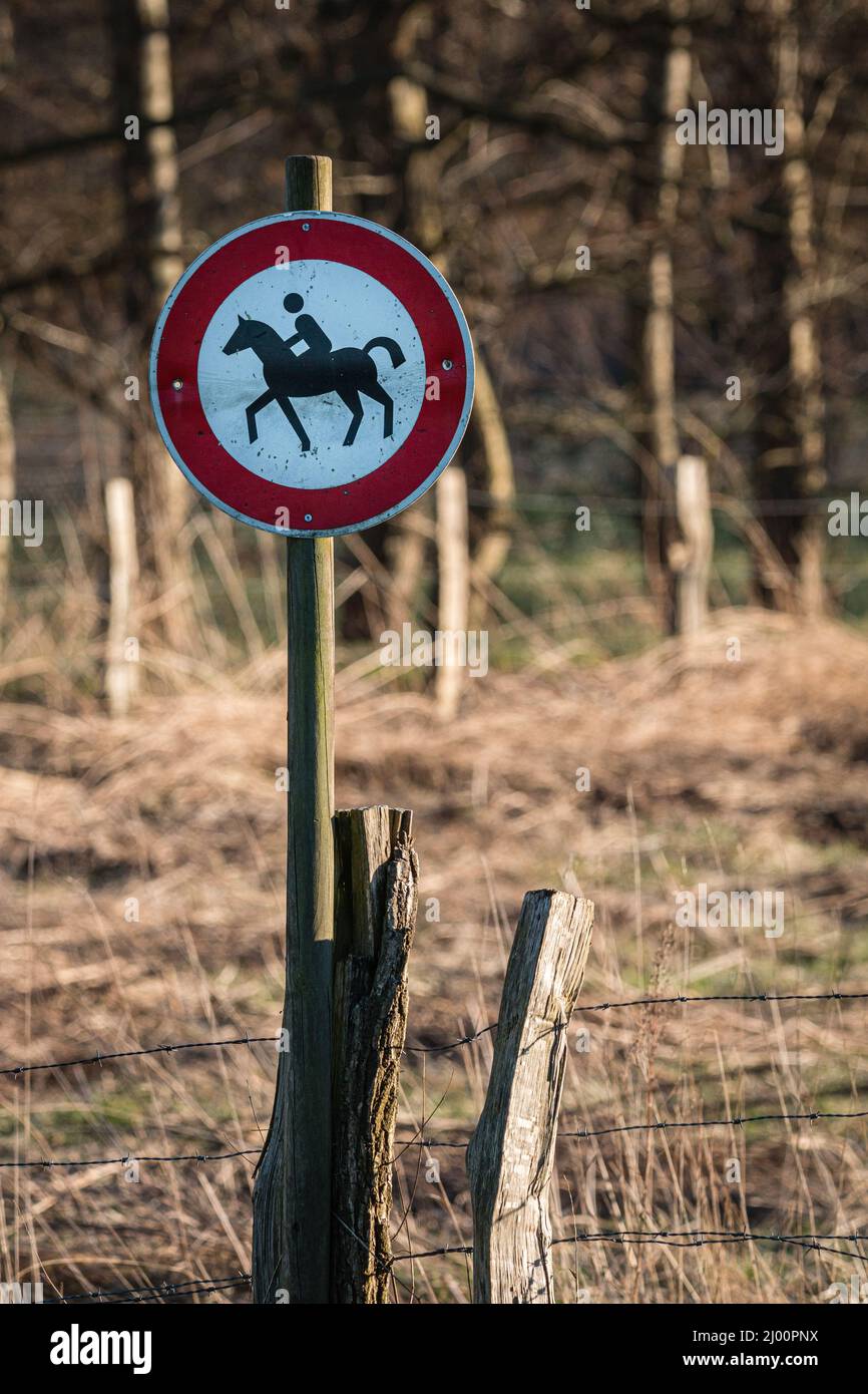 A metal sign indicating that riding is prohibited Stock Photo - Alamy