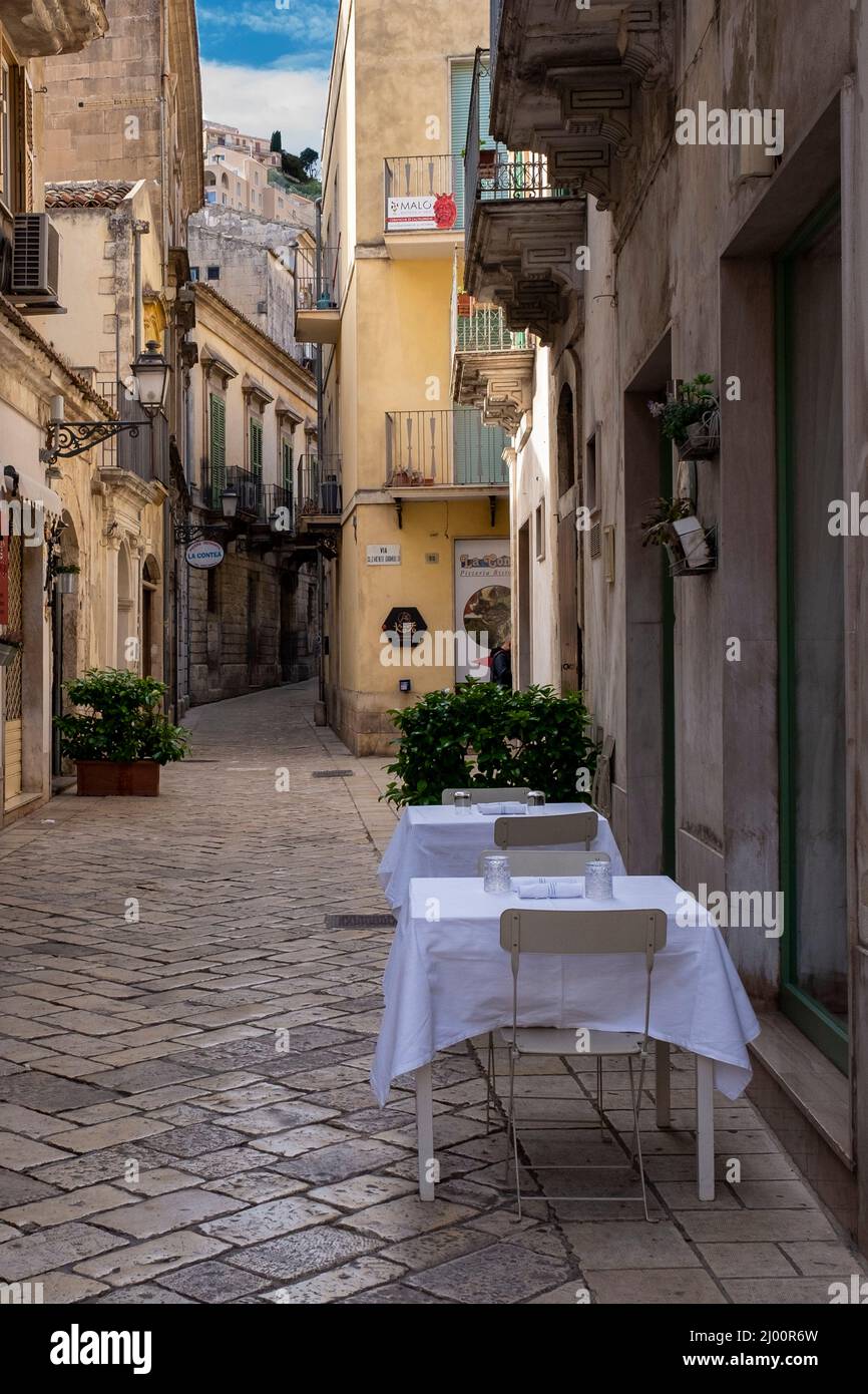 Outdoor Restaurant Seating on quaint narrow Street Stock Photo - Alamy