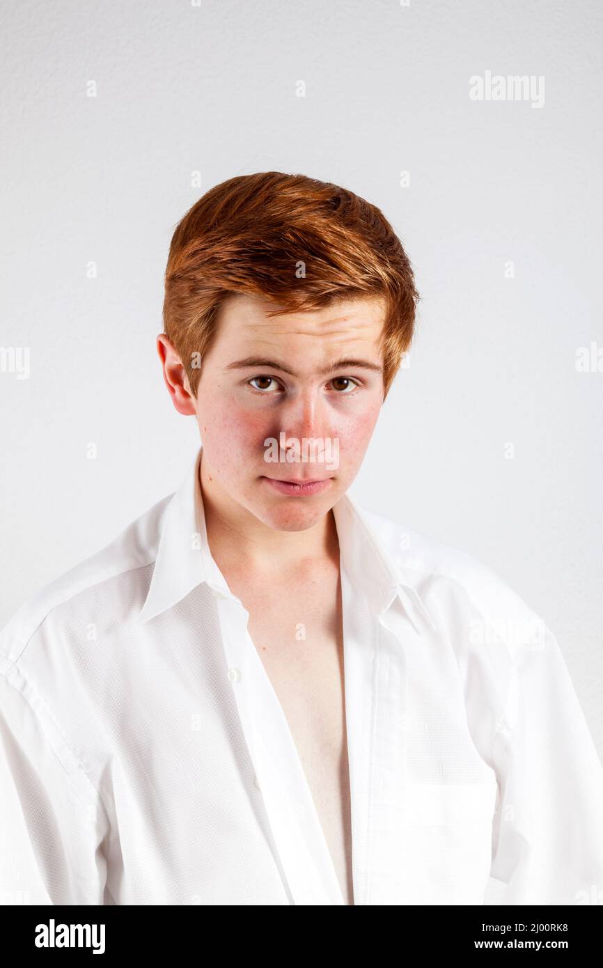 Boy buttoning his shirt hi-res stock photography and images - Alamy