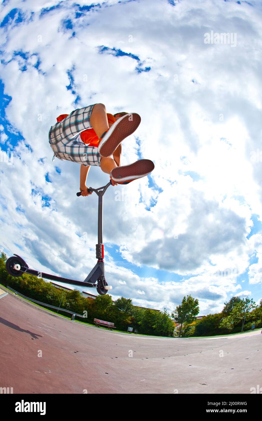boy going airborne with his scooter Stock Photo - Alamy