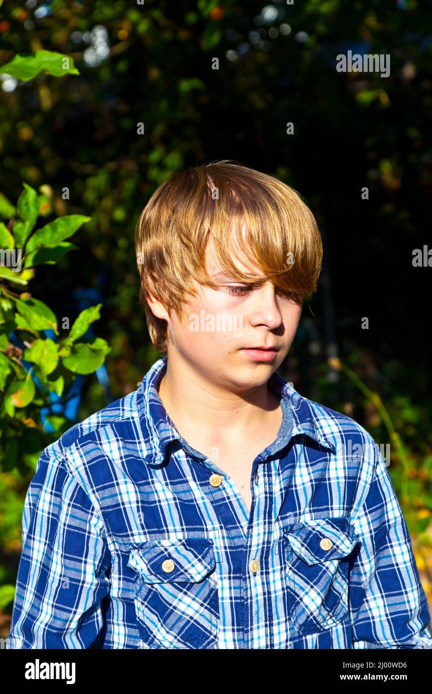 portrait of angry boy in leaves of the tree Stock Photo - Alamy