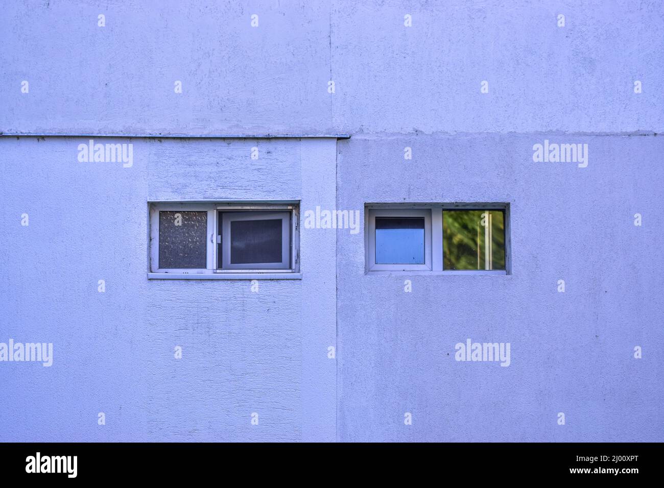 Beautiful shot of two small windows of a light blue building in Iasi ...