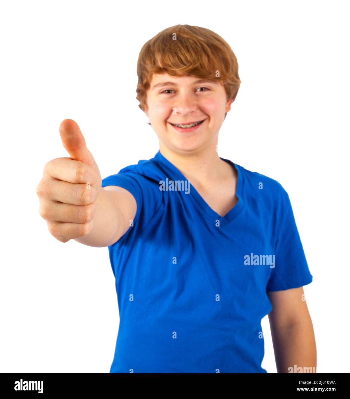 A smiling boy is showing his thumb up; isolated on the white background ...