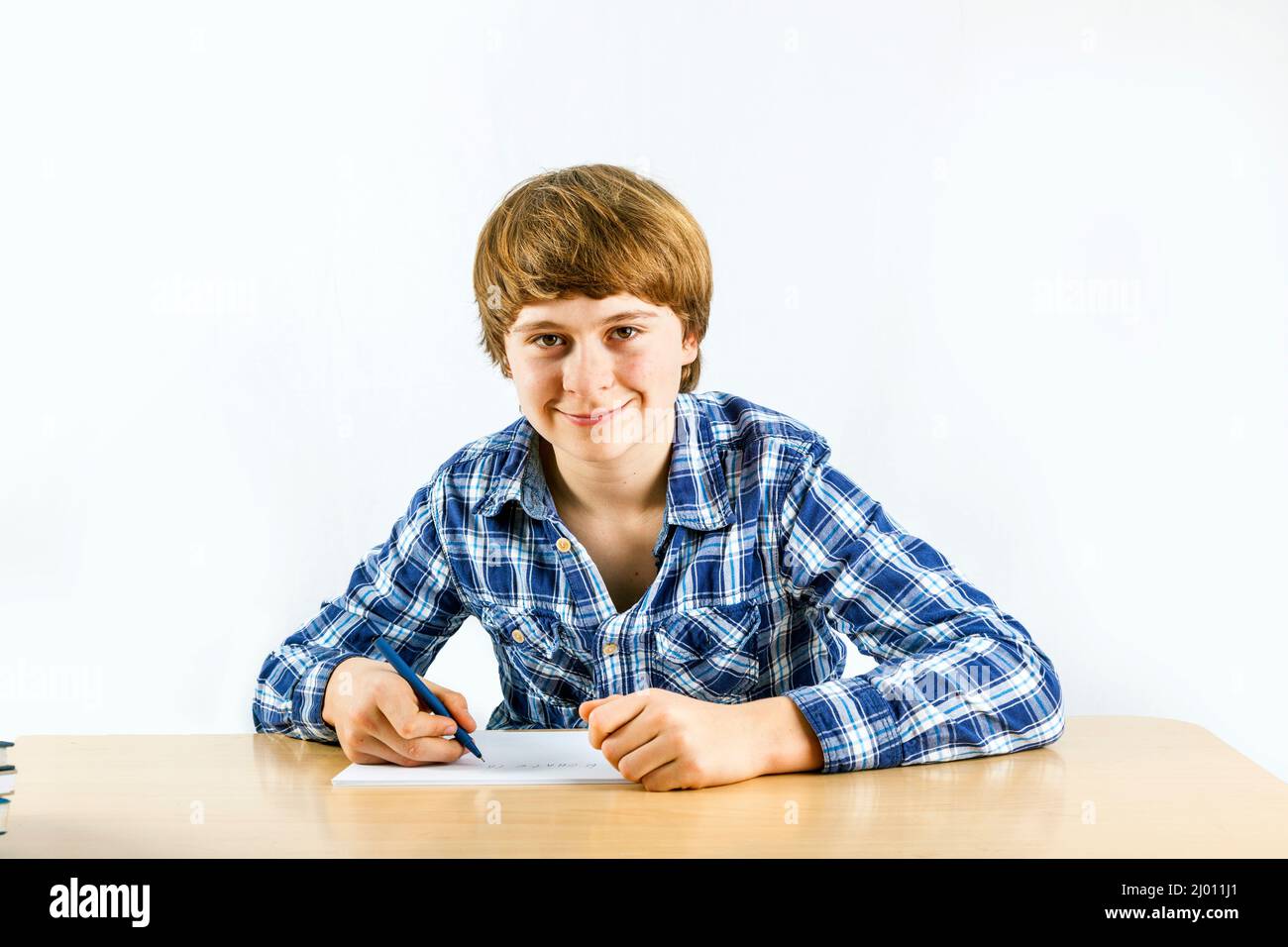 smart boy learning for schooland writing in a book Stock Photo - Alamy