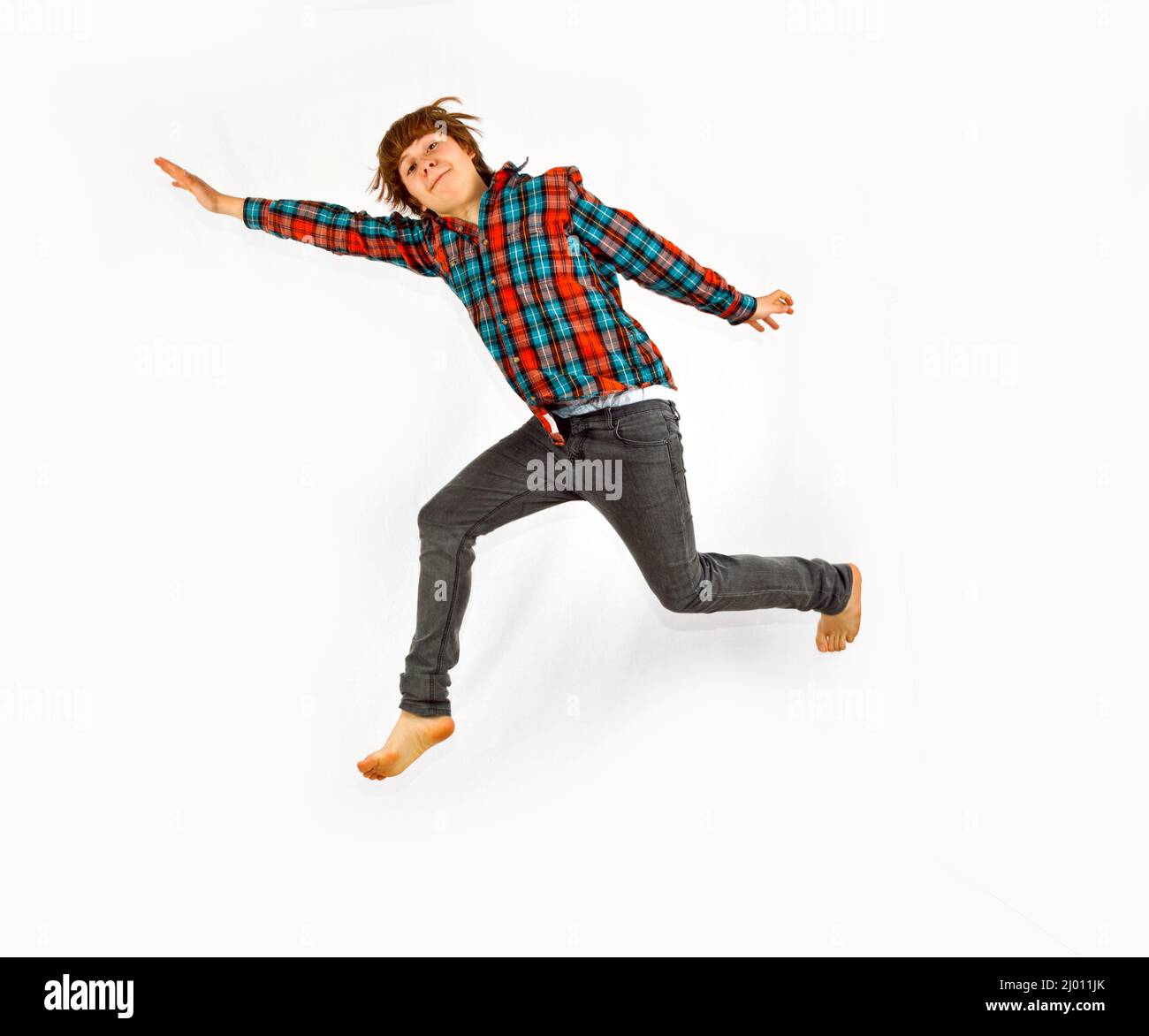 Portrait Of Teenage Boy Jumping In The Air Stock Photo - Alamy