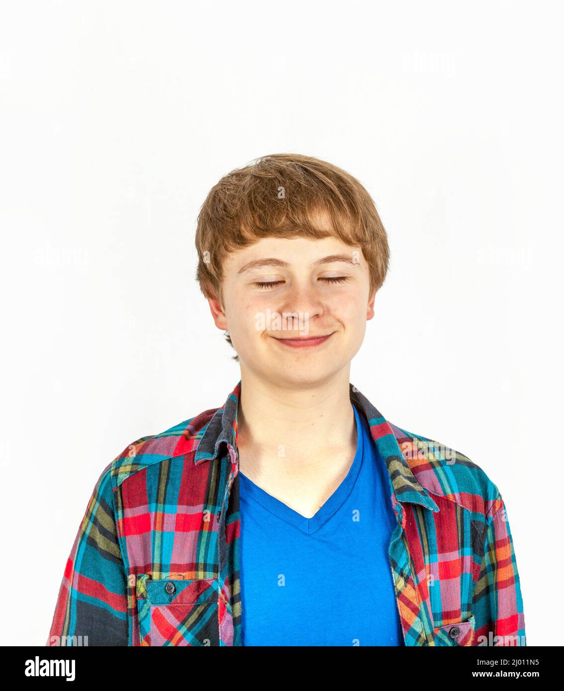happy friendly teenage boy in studio with closed eyes Stock Photo - Alamy