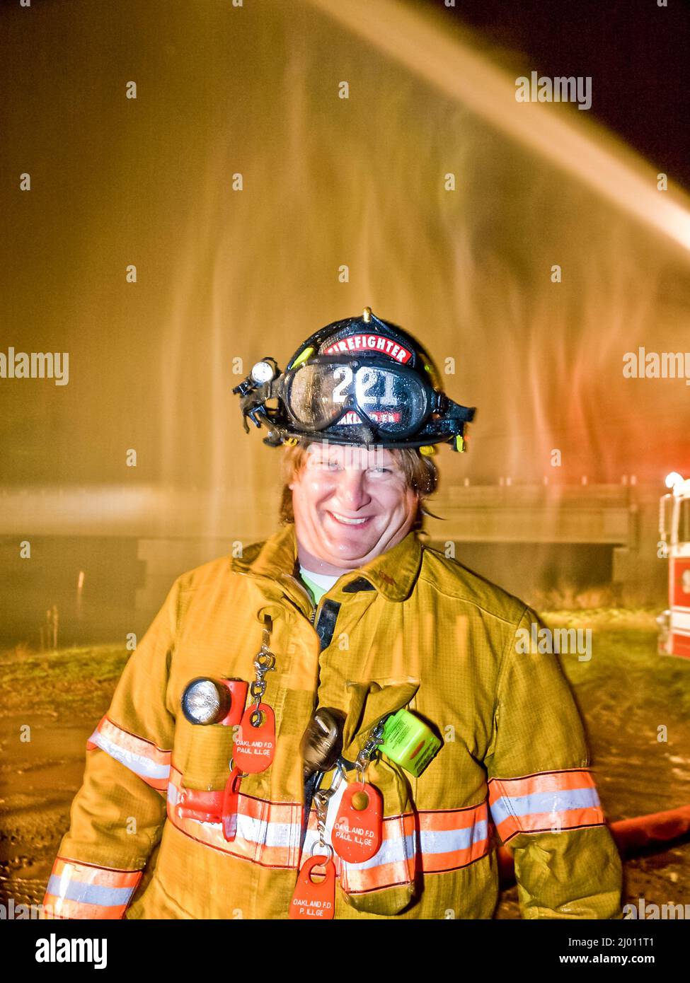 Firefighters in action at night with truck and water cannon Stock Photo ...