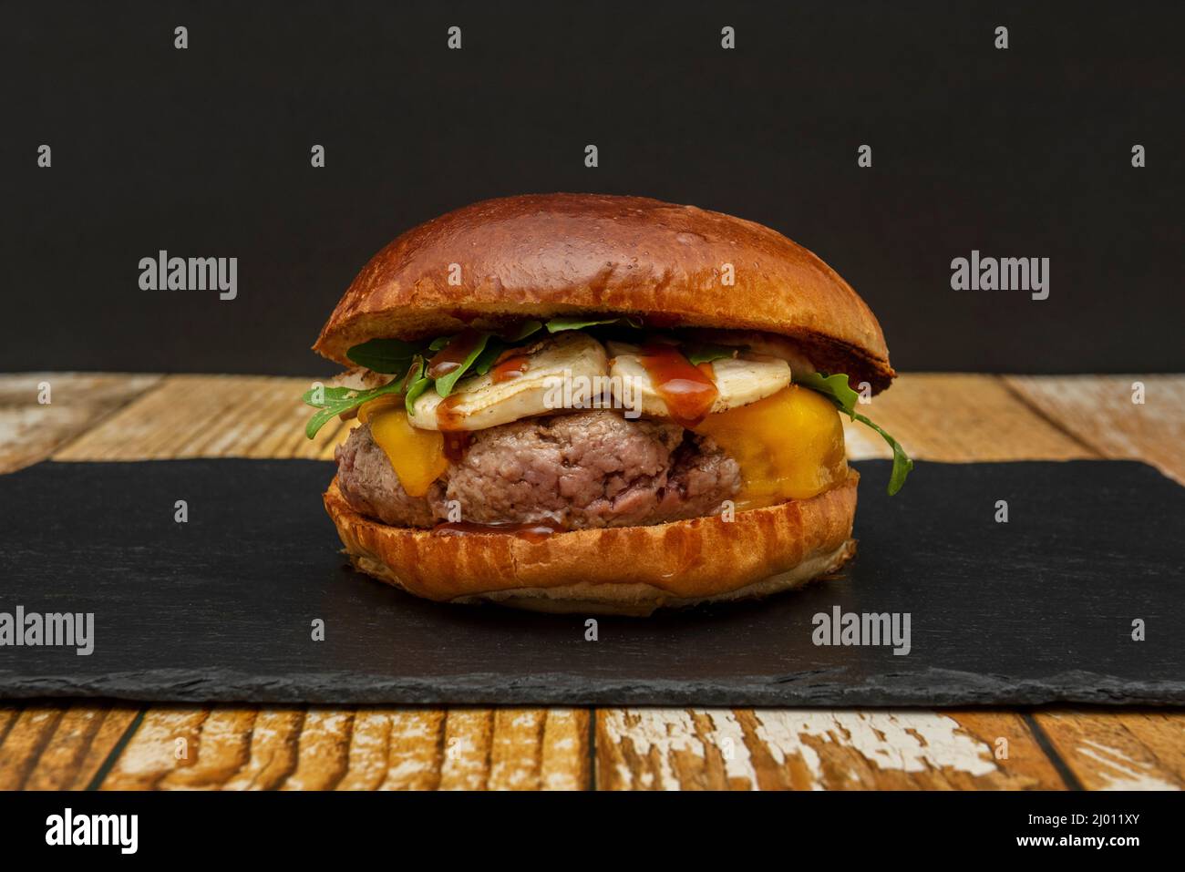 beef burger with arugula, mushrooms, barbecue sauce and cheddar cheese ...