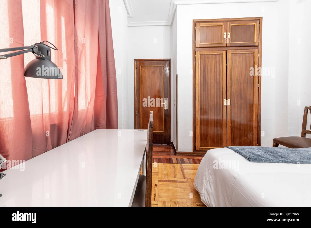 Room study table and fitted wardrobes with bright wooden doors Stock ...