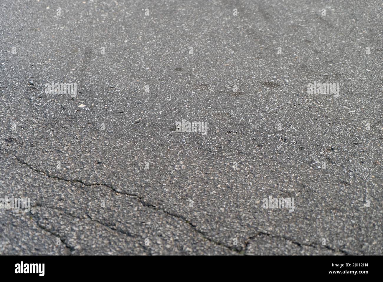 Weathered asphalt road with cracks Stock Photo - Alamy