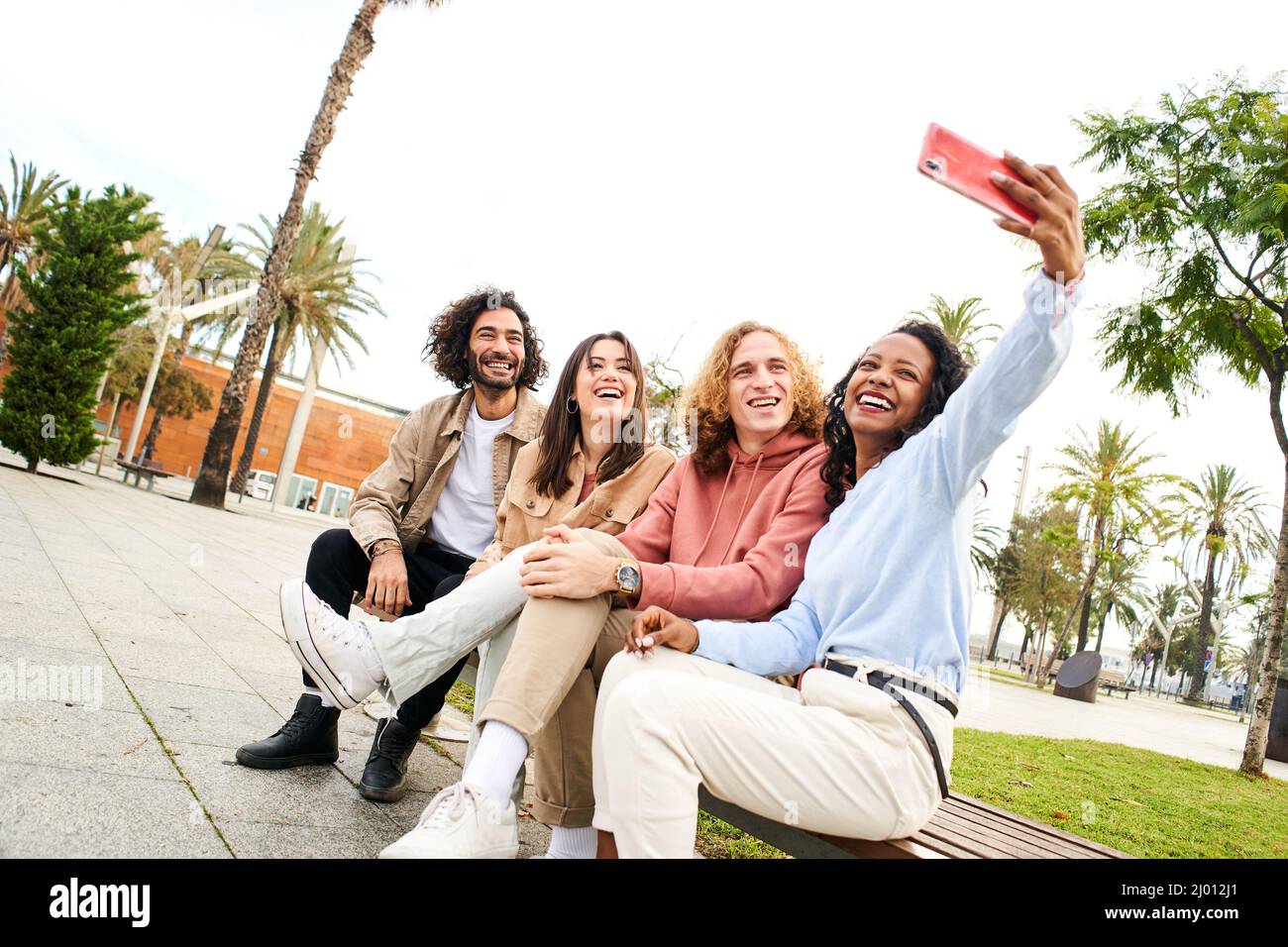 Beautiful woman taking selfie with a friends. Group of multi-ethnic ...
