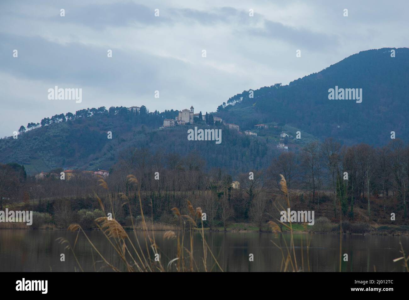 view of the small Italian town Castelvecchio di Compito from the lake ...