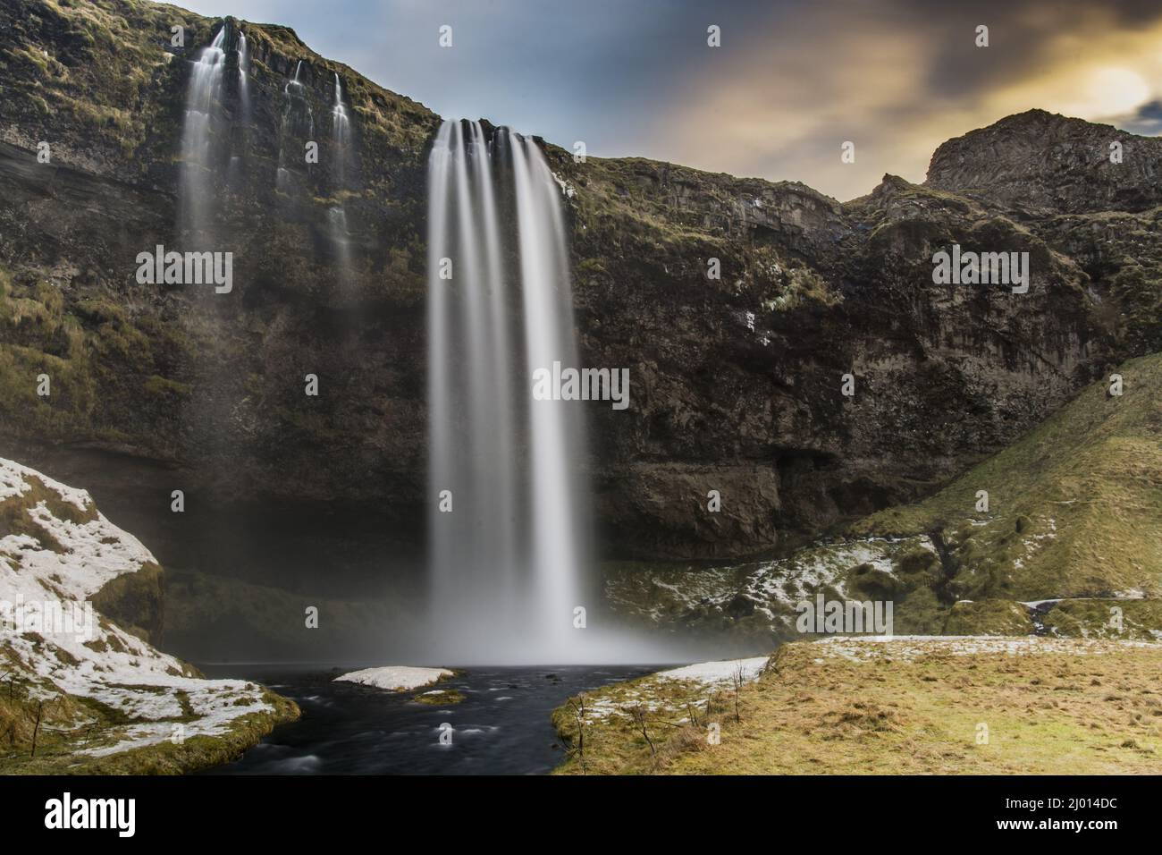 Mesmerizing nature scene of a waterfall pouring from the cliffs Stock ...