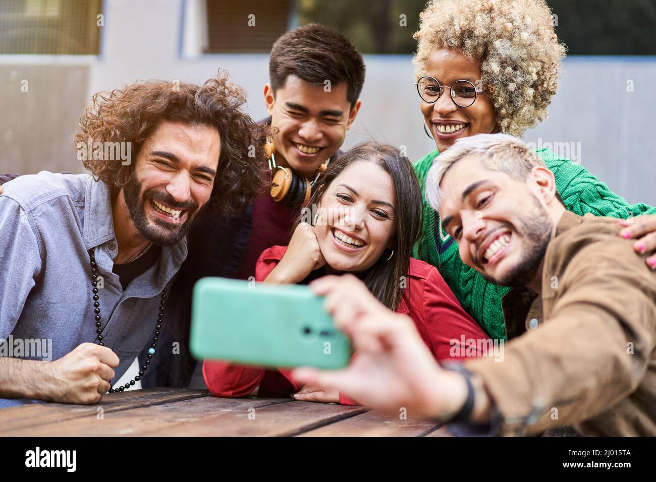 Happy multiracial friends having fun taking selfie - Young happy people ...