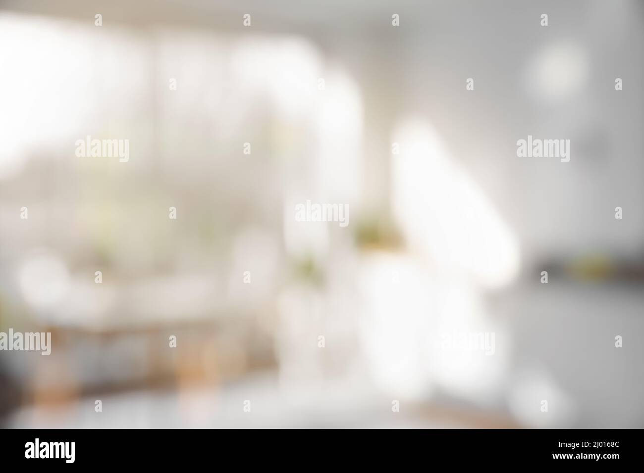 Blurred view of light kitchen with counters and window Stock Photo - Alamy