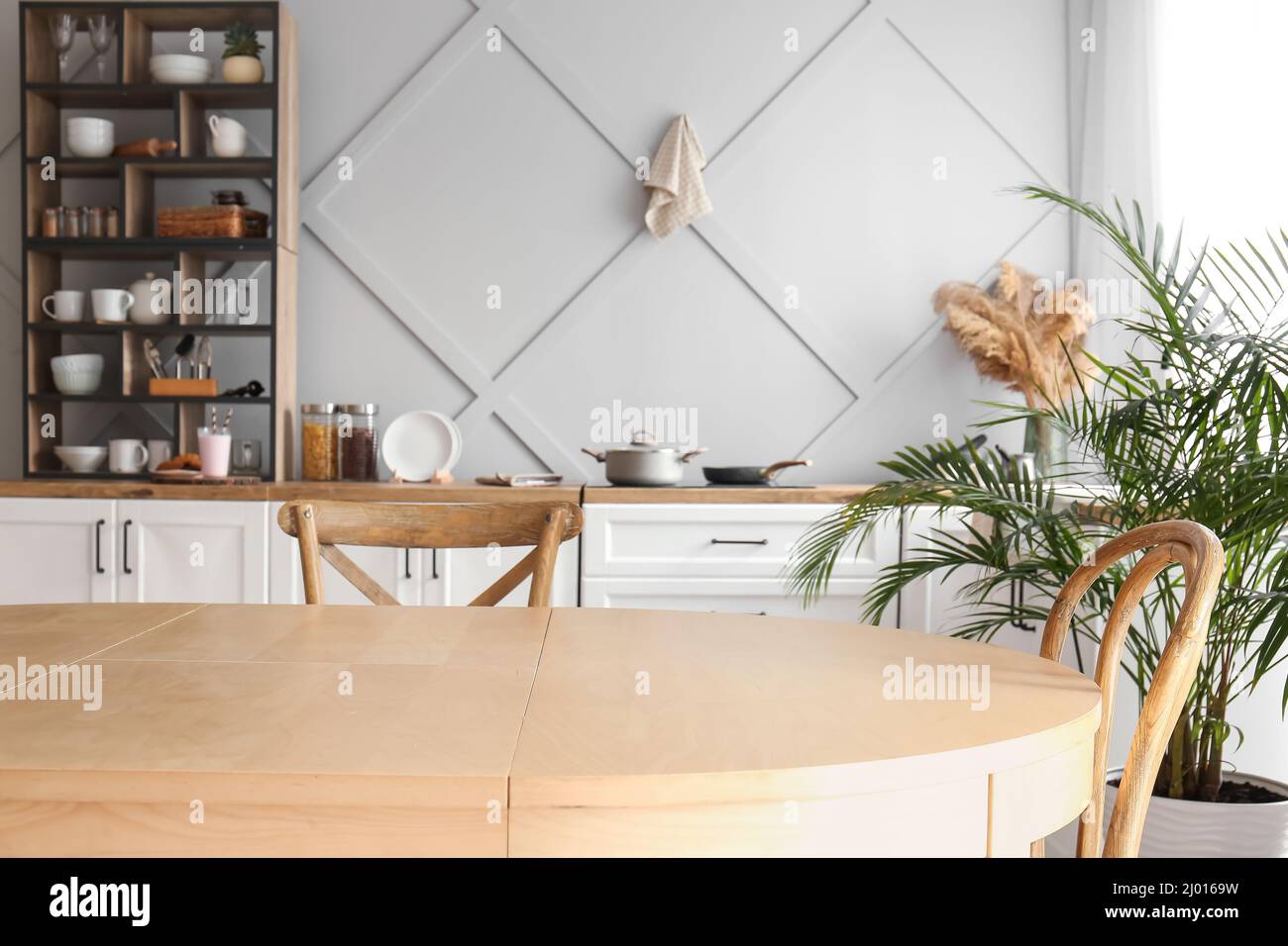 Empty dining table with chairs in modern kitchen Stock Photo - Alamy