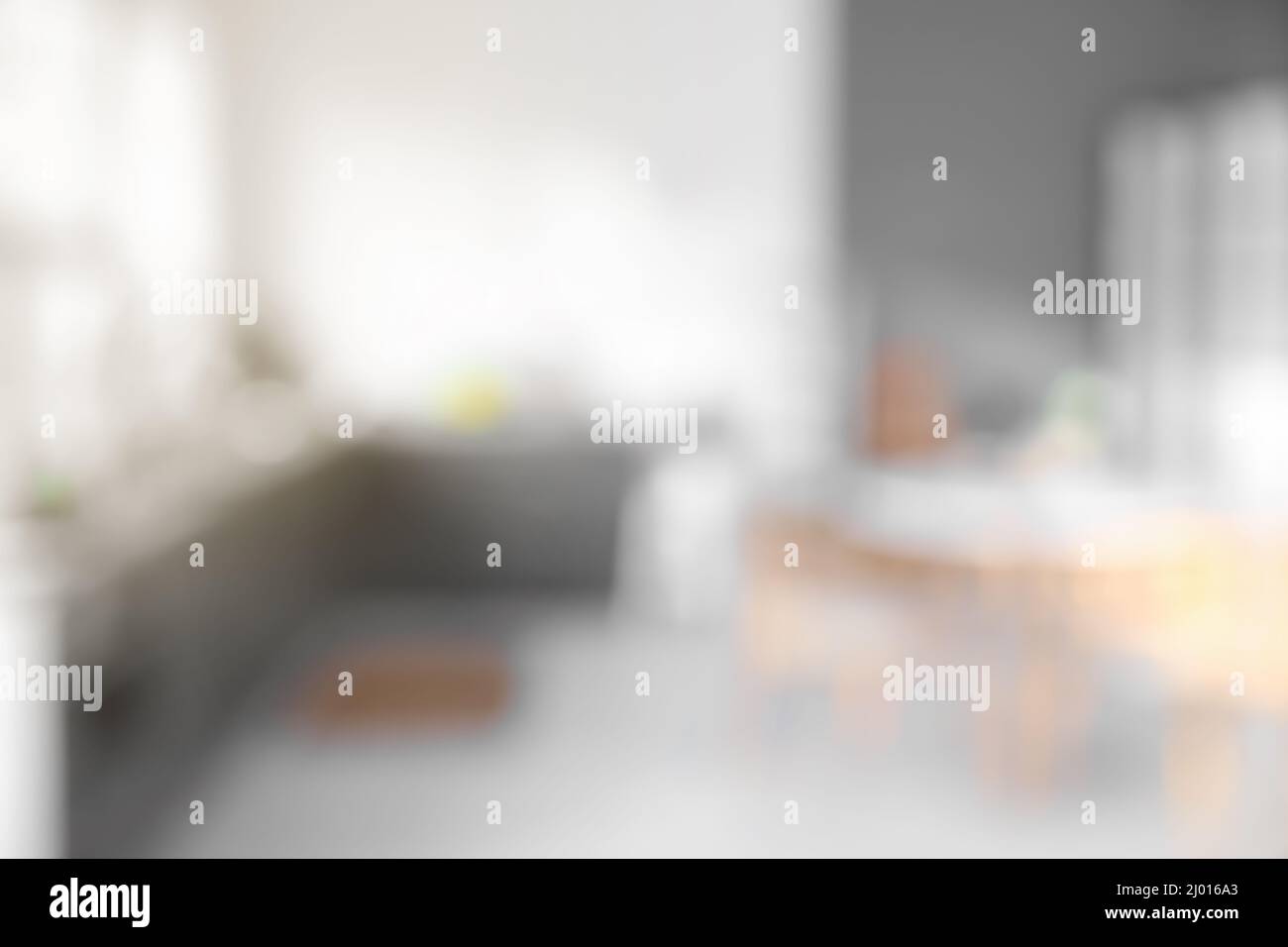Blurred view of modern kitchen with counters and dining table Stock ...