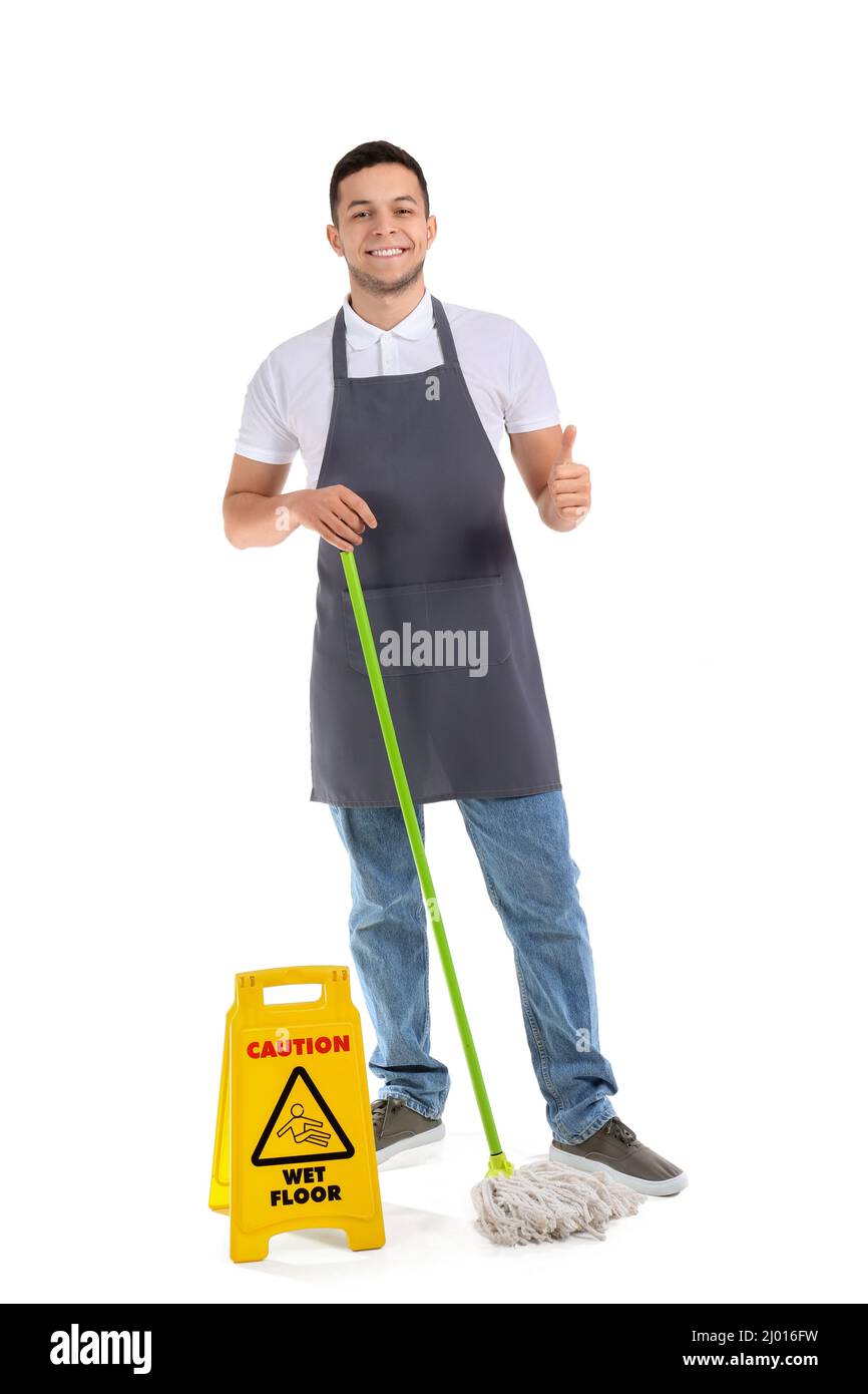 Young male worker of cleaning service with mop and caution sign showing ...