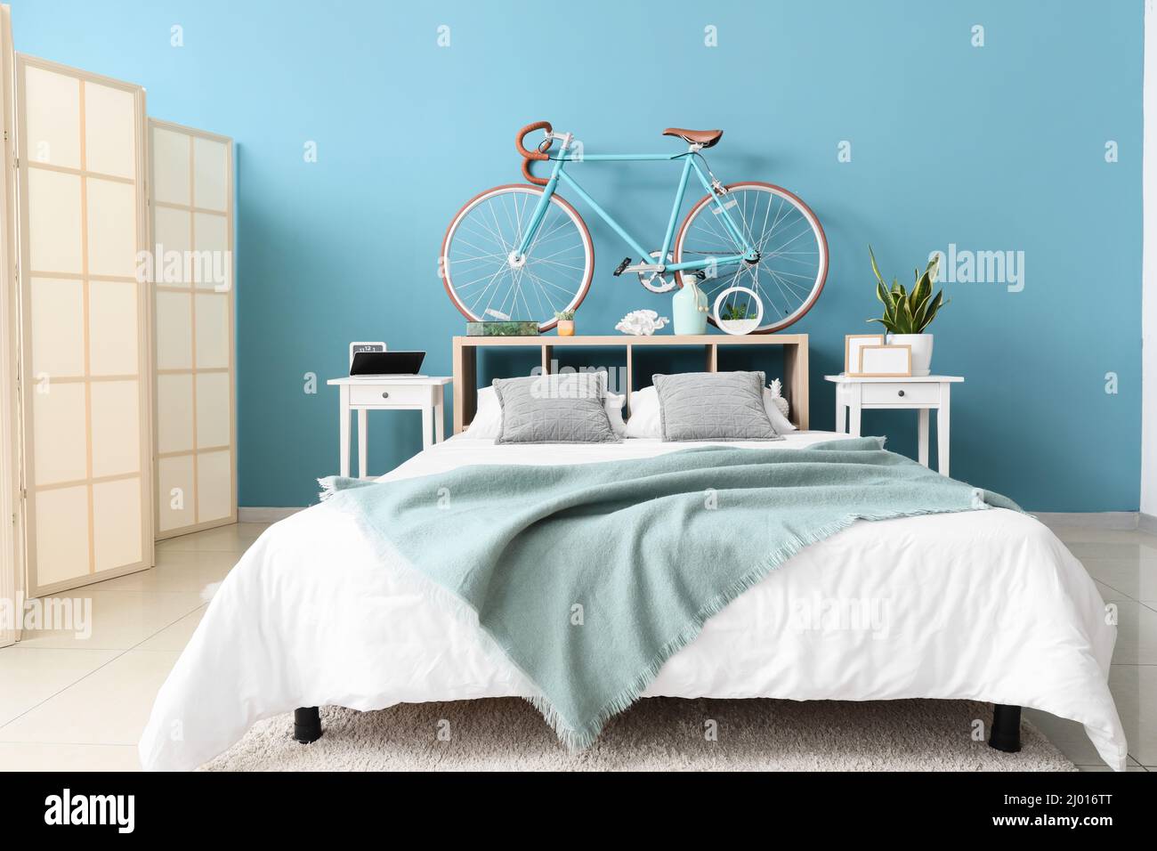 Interior of stylish bedroom with modern bicycle Stock Photo - Alamy