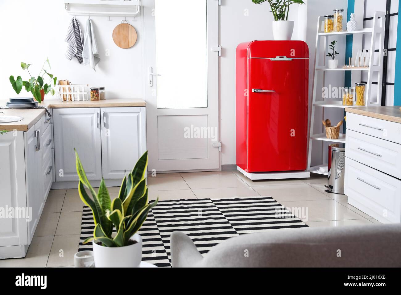 Red vintage fridge in interior of kitchen Stock Photo - Alamy