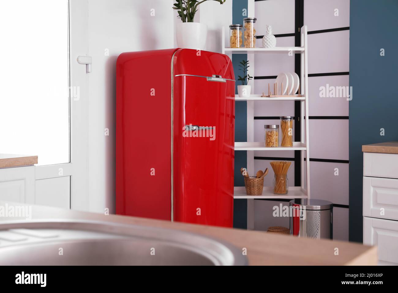 Red vintage fridge in interior of kitchen Stock Photo - Alamy