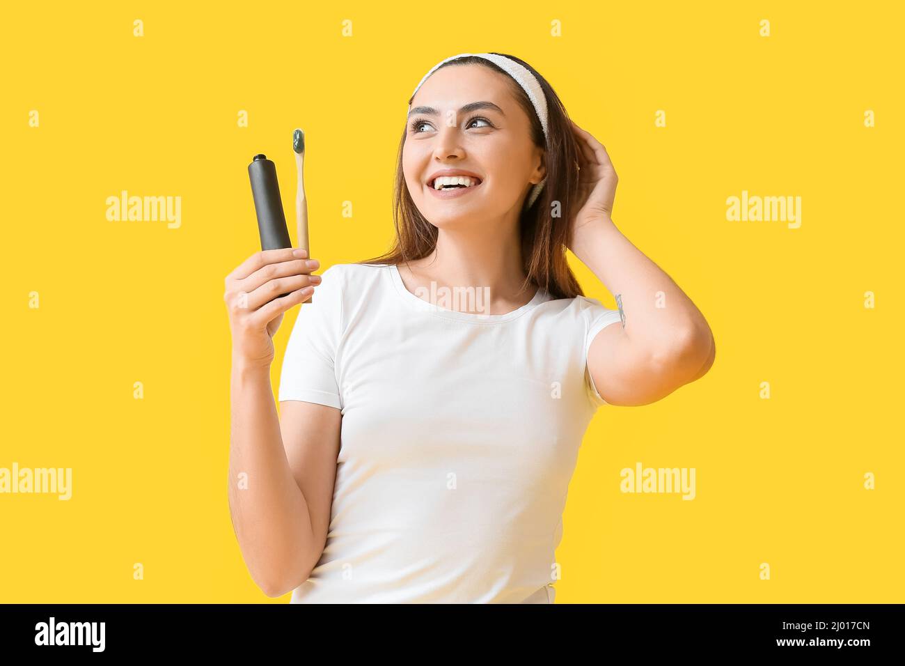 Beautiful young woman with activated charcoal tooth paste and brush on ...