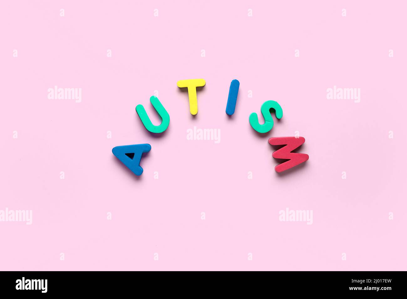 Colorful word AUTISM on pink background Stock Photo - Alamy