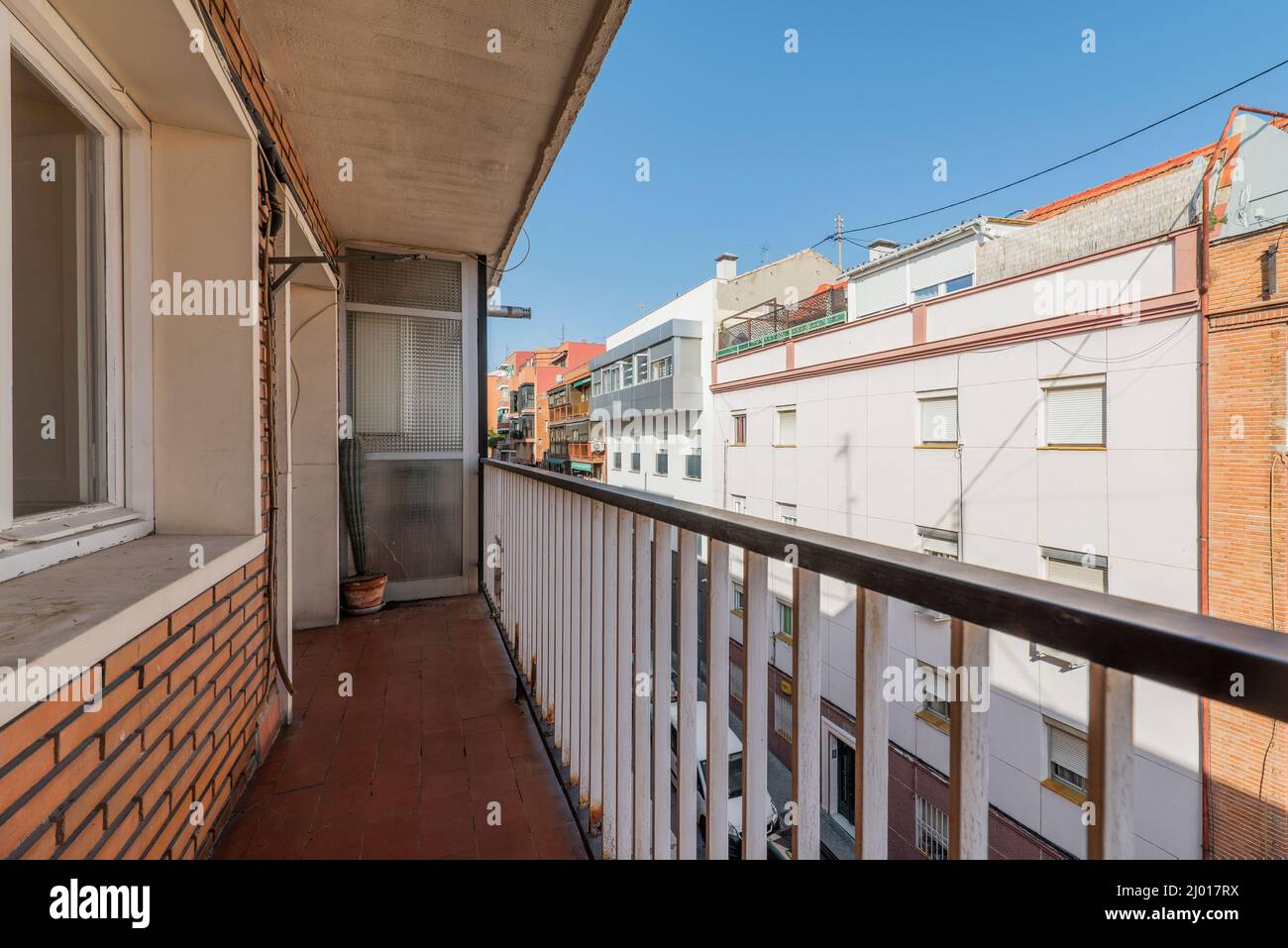 Open terrace with painted iron railing and views of a street Stock ...