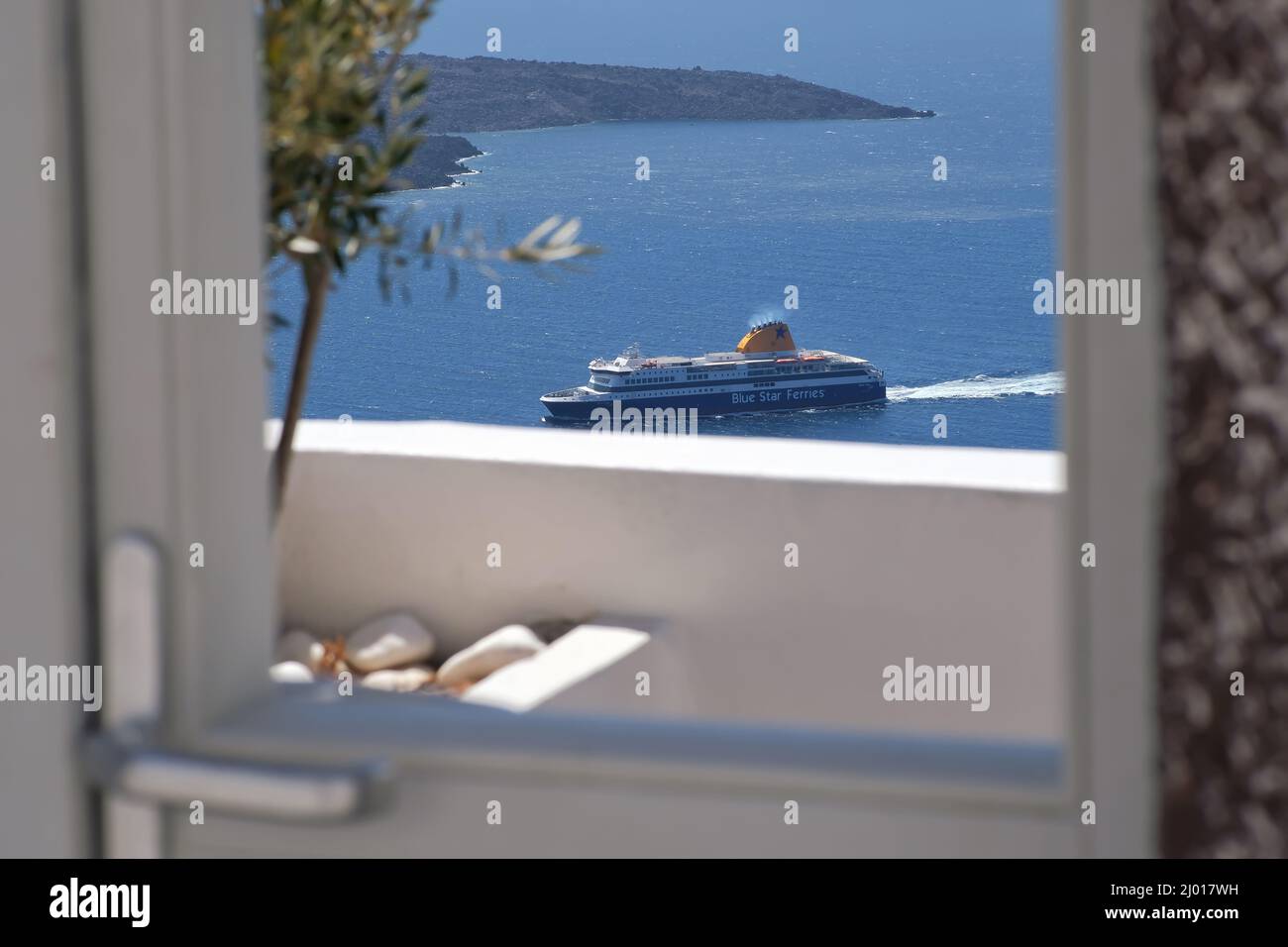 Santorini, Greece - May 10, 2021 : View through a window frame and a ...