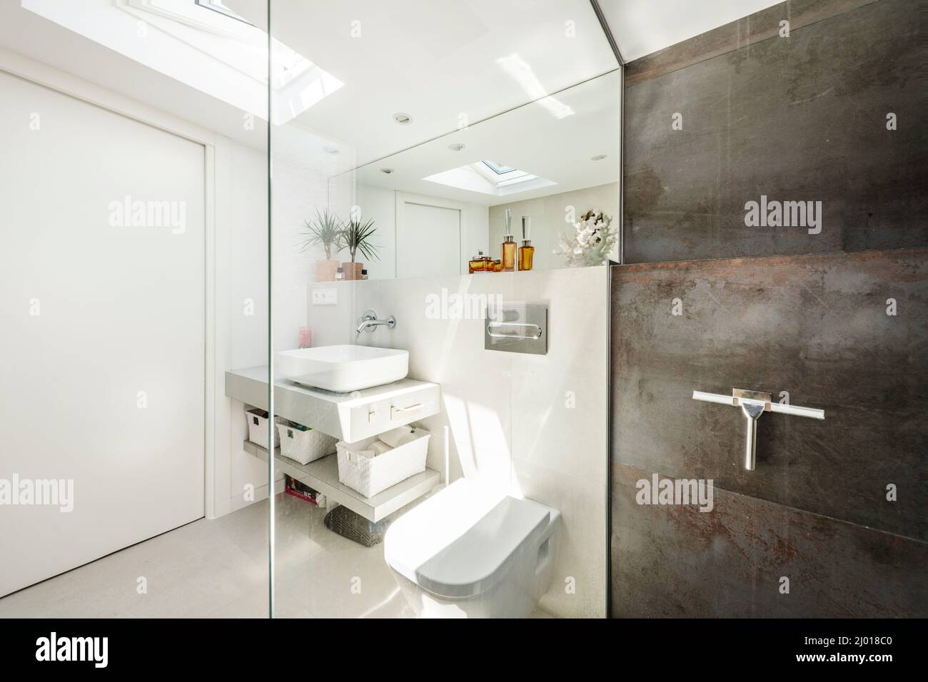 Attic toilet with sloping ceilings with glass shower screen, long ...