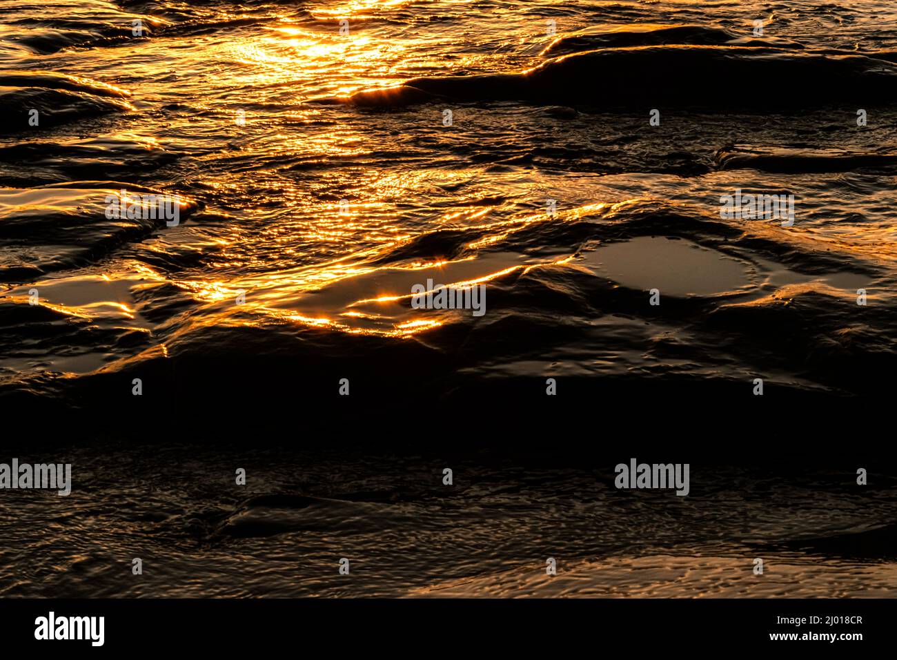 Close-up shot of sea waves in the sunset Stock Photo - Alamy