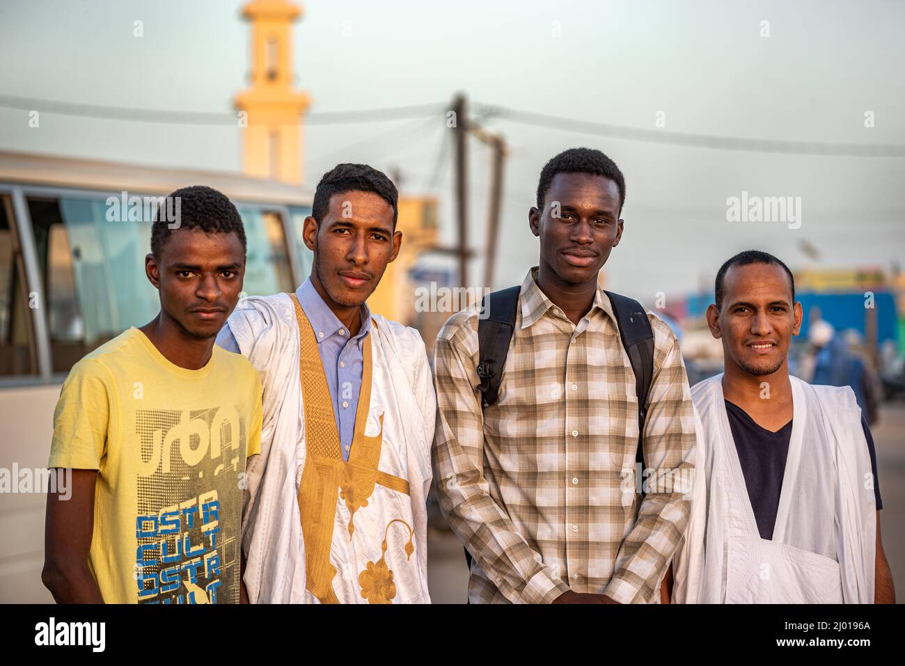 Four young men of different ethnicities posing for a group picture ...