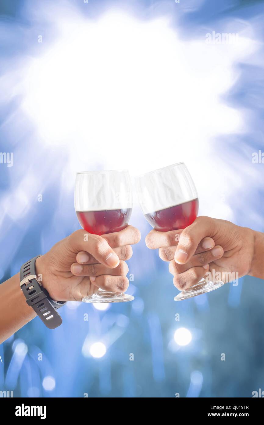 Close-up shot of hands toasting with red wine isolated on a shiny ...