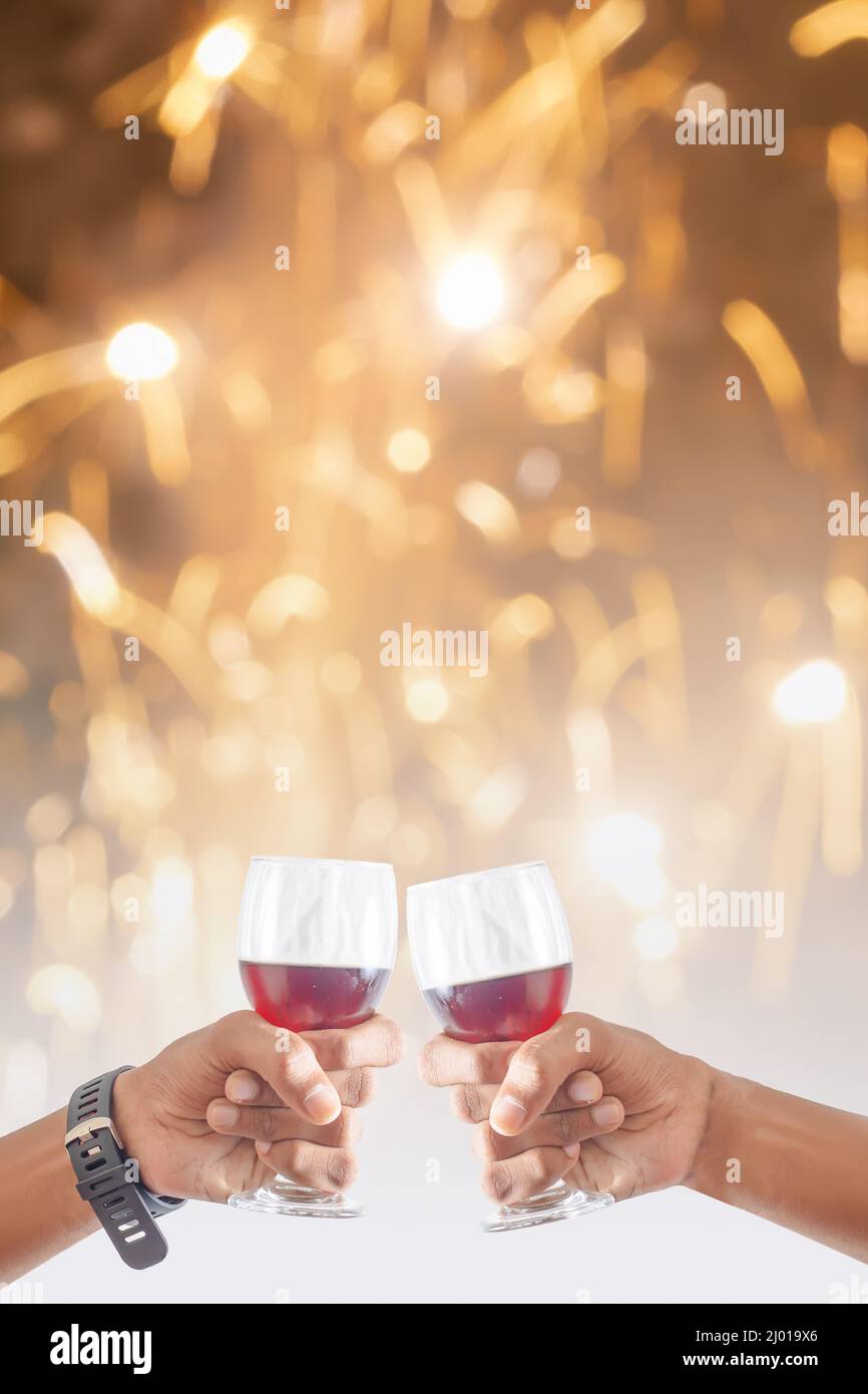 Close-up shot of hands toasting with red wine isolated on a shiny ...