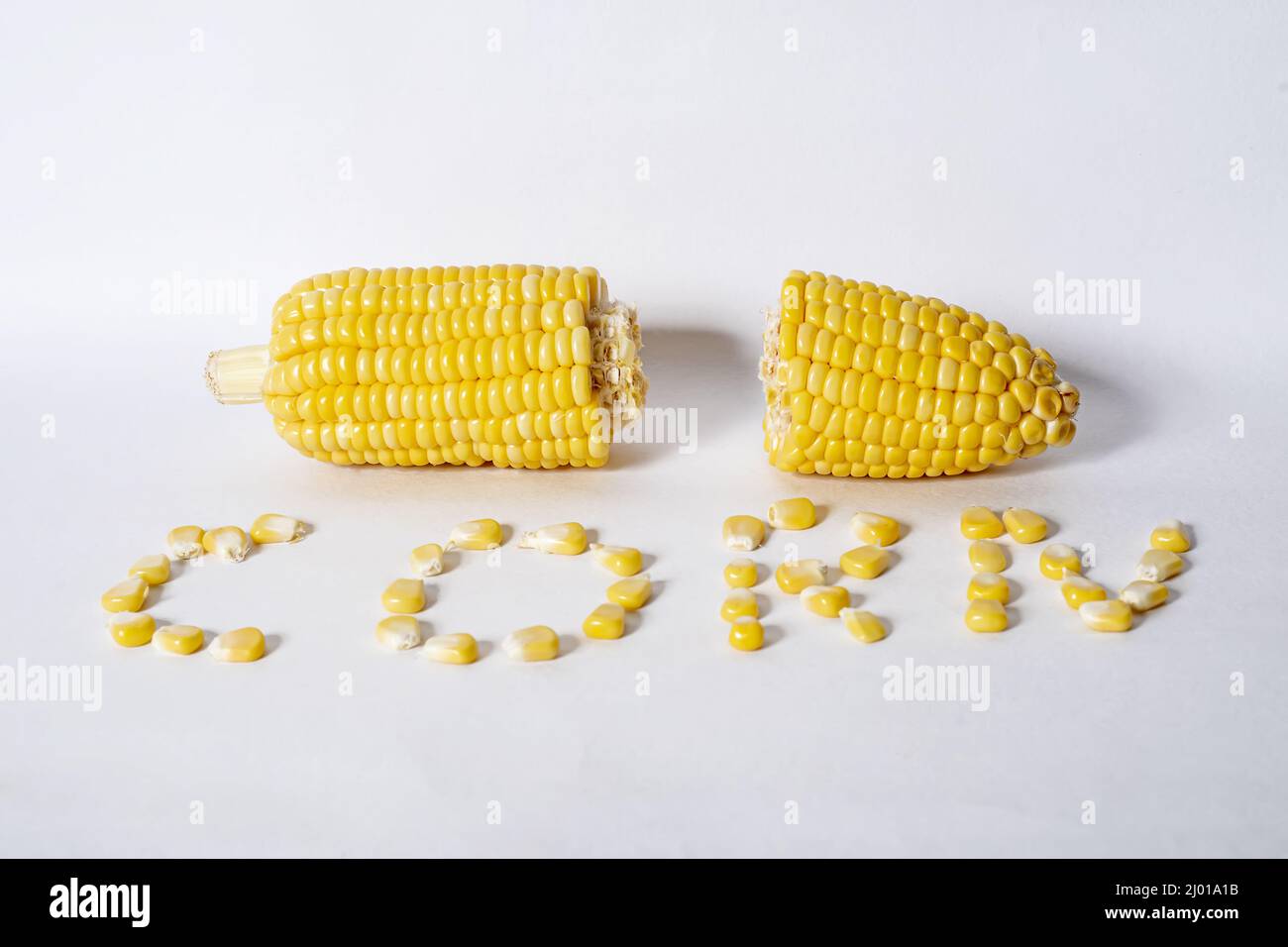 Corn kernels forming the word "corn" on isolated white background Stock ...