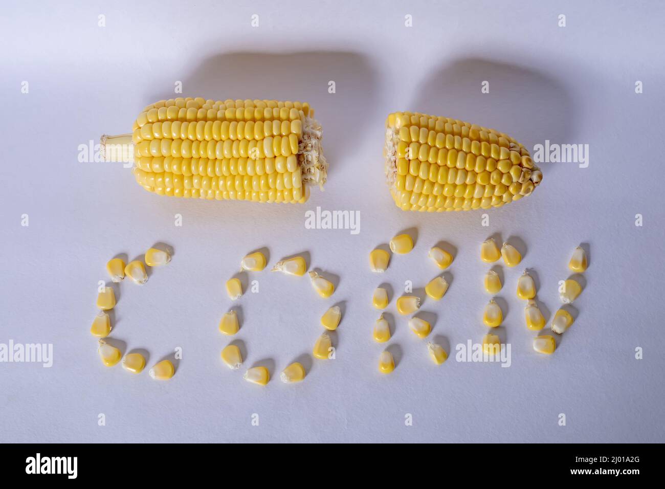 Corn kernels forming the word "corn" on isolated white background Stock ...