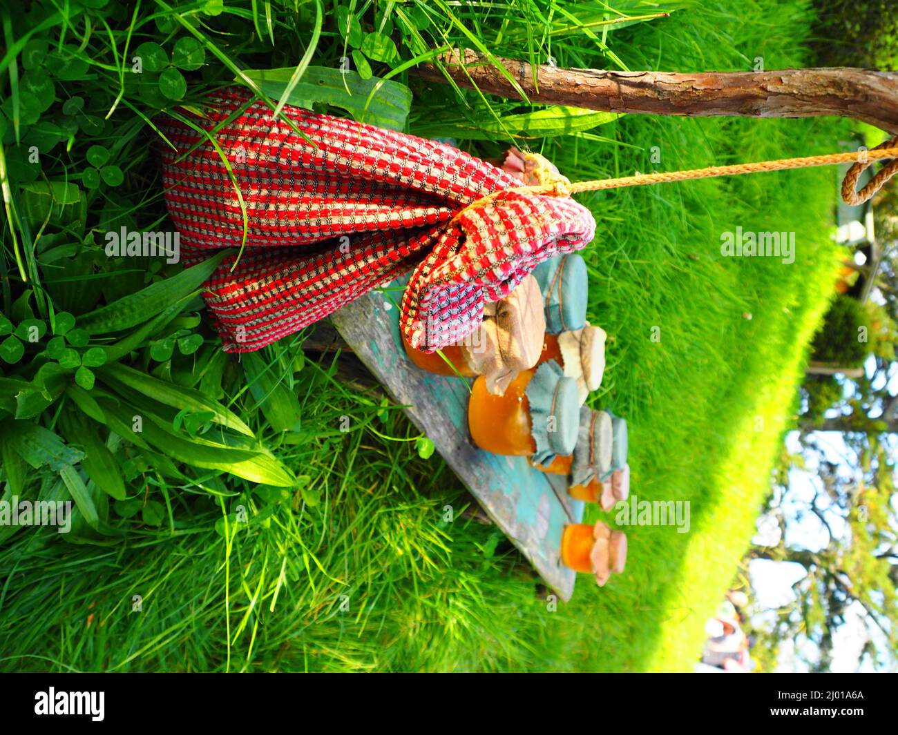 Vertical shot of honey pots during harvest on the wooden board on a ...