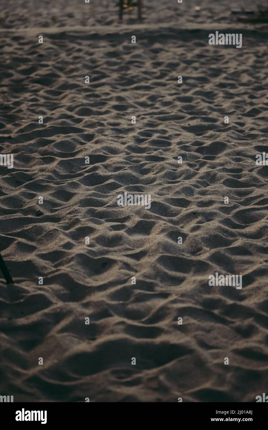 Vertical shot of beautiful sand of the beach on a sunny day Stock Photo ...