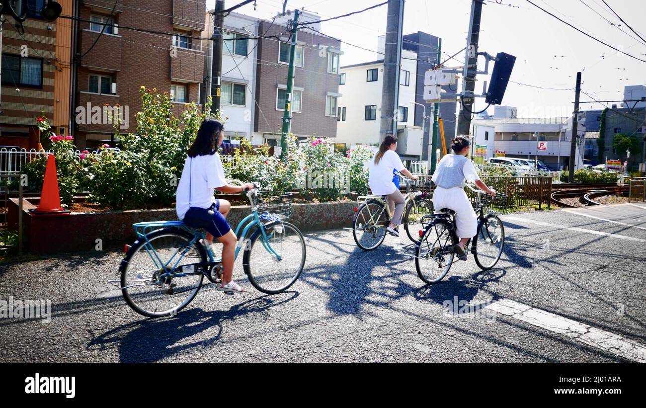 Group of girls riding bikes in the summertime in Tokyo, Japan Stock ...