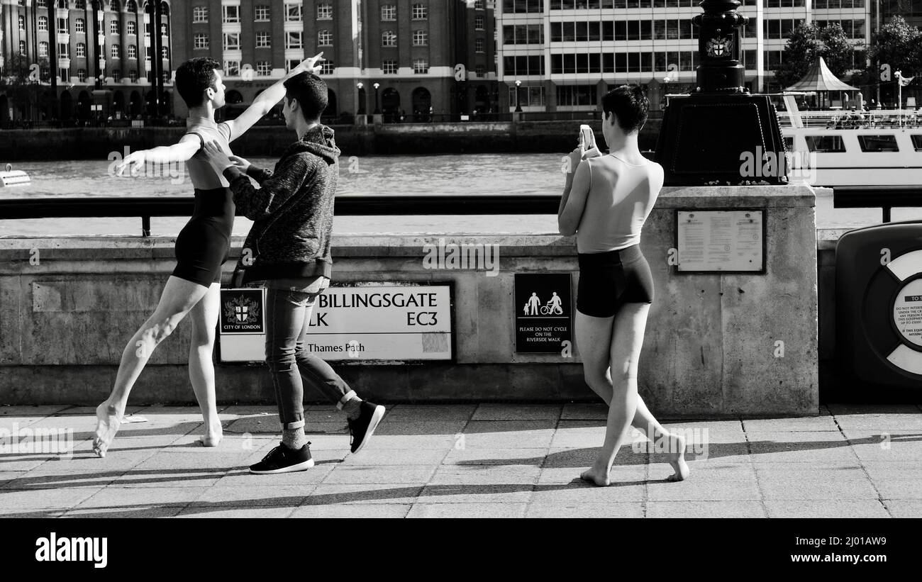 Grayscale of boys dancing at the London bridge in the United Kingdom ...