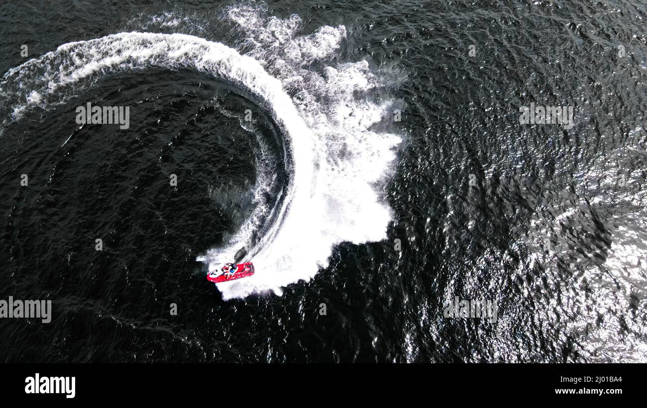 Aerial shot of a red boat drifting in the sea Stock Photo - Alamy